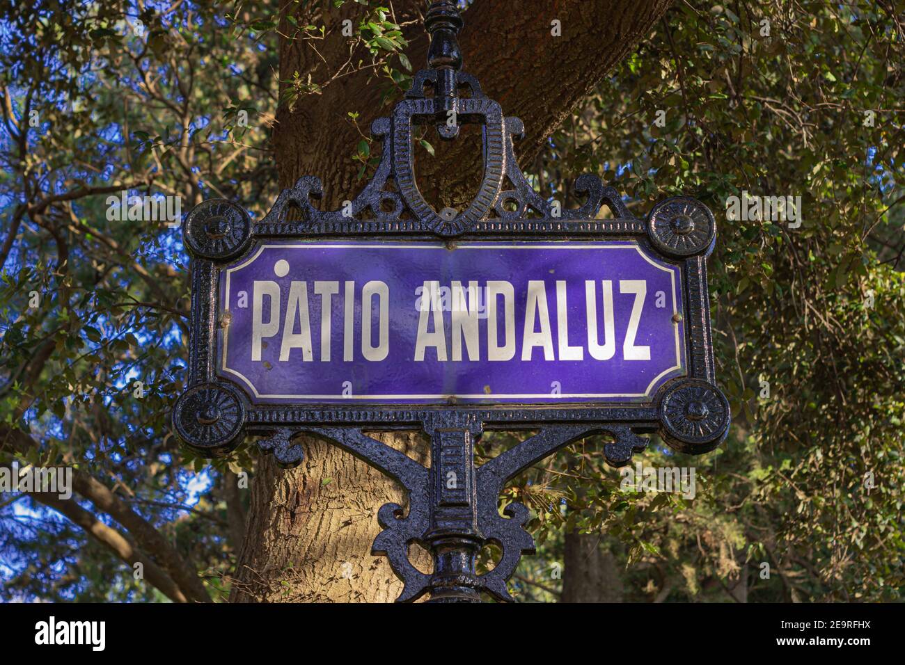 Old blue and white sign indicating in spanish Andalusian courtyard ...