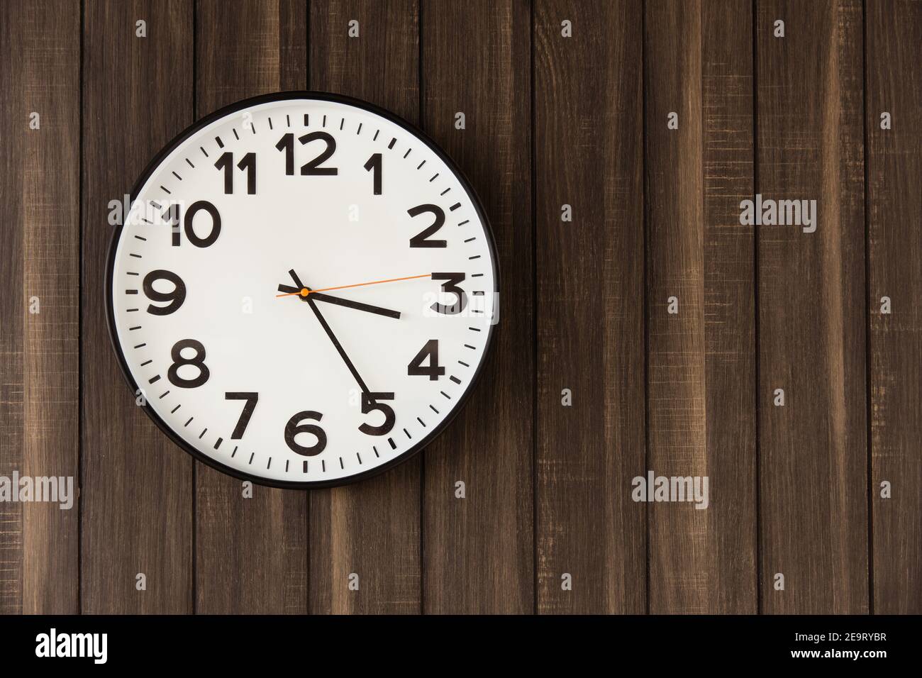 Time Clock hang on dark wooden wall background space for text Stock ...