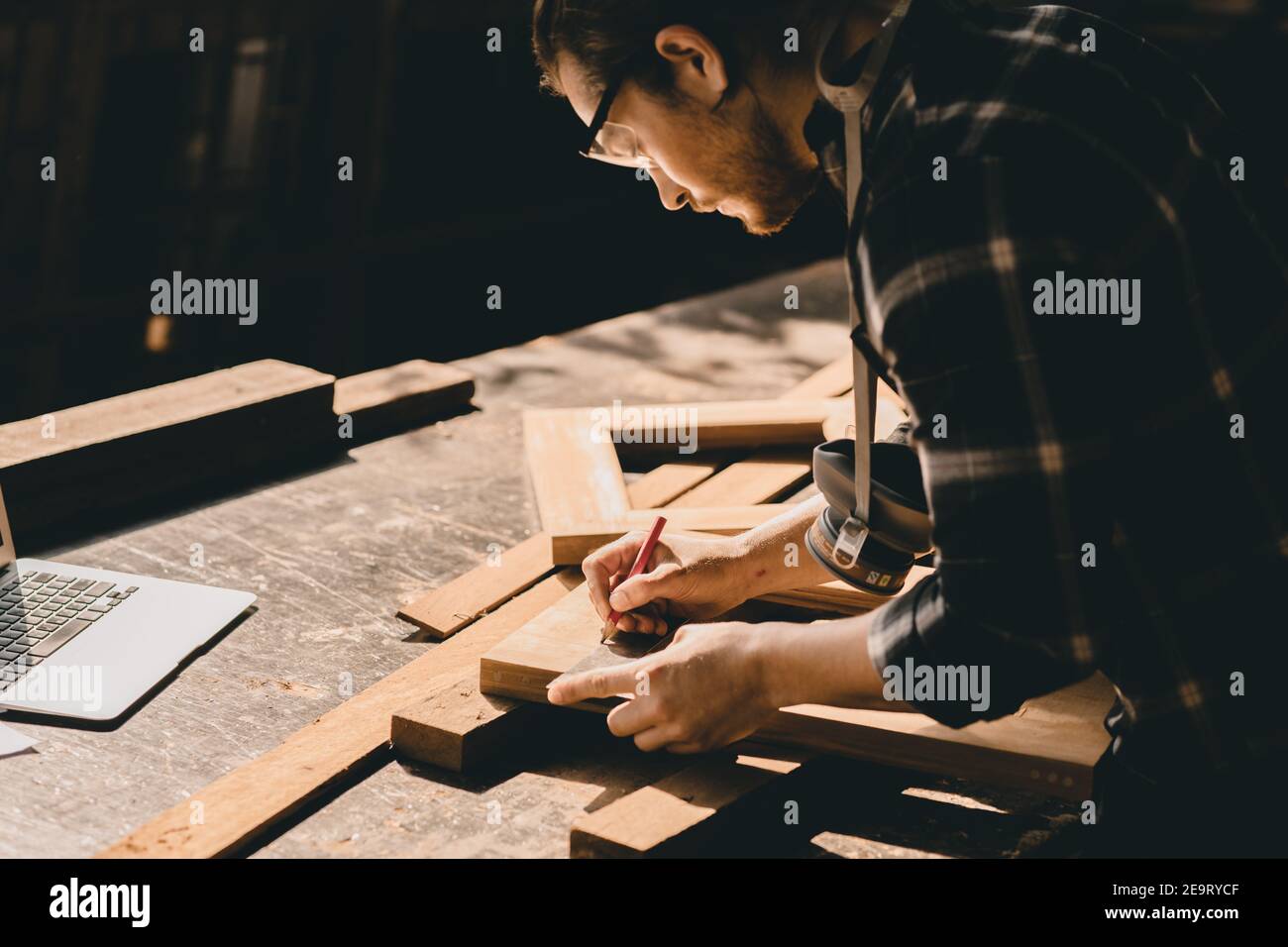 Carpenter man woodcraft working in furniture wood workshop with ...