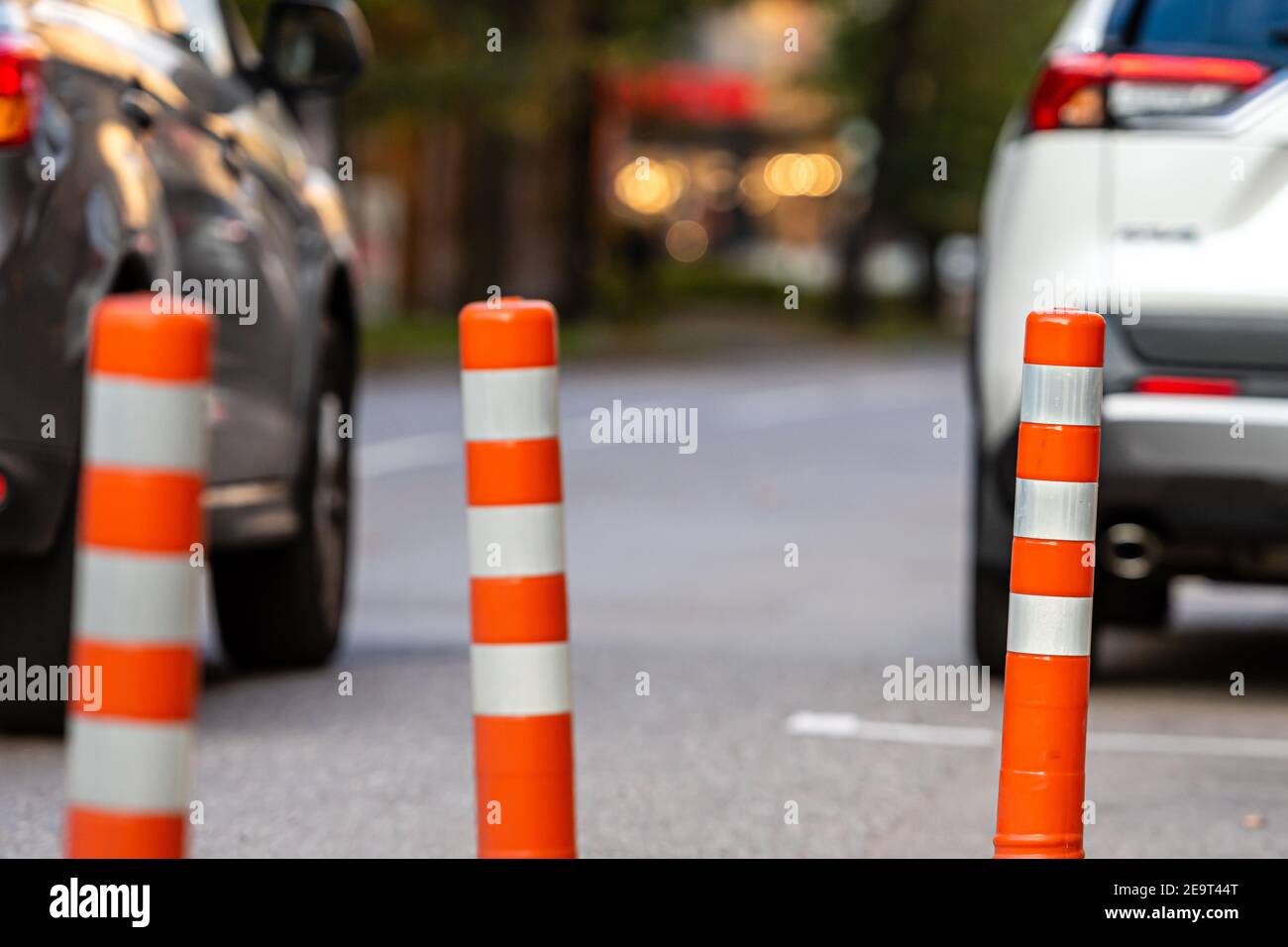 red and white traffic bollard that separate car traffic from the ...