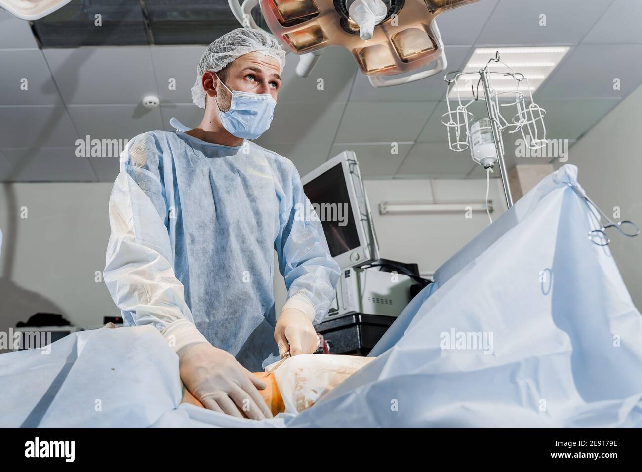 Surgeon removes fat in the gluteal region. Abdominoplasty - plastic ...