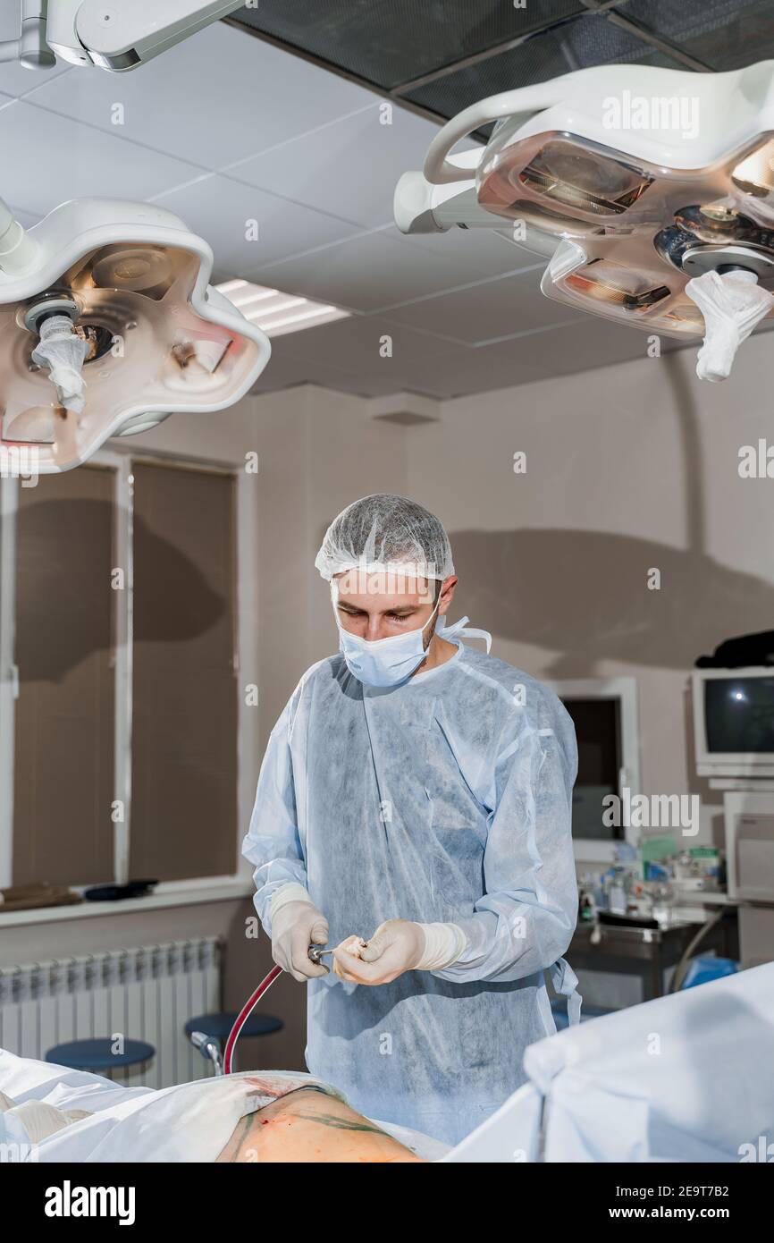 Surgeon removes fat in the gluteal region. Abdominoplasty - plastic ...