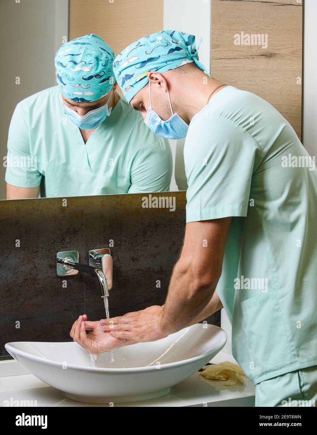 Hygiene of man. Medical staff wash hands. Disinfection for hands under ...