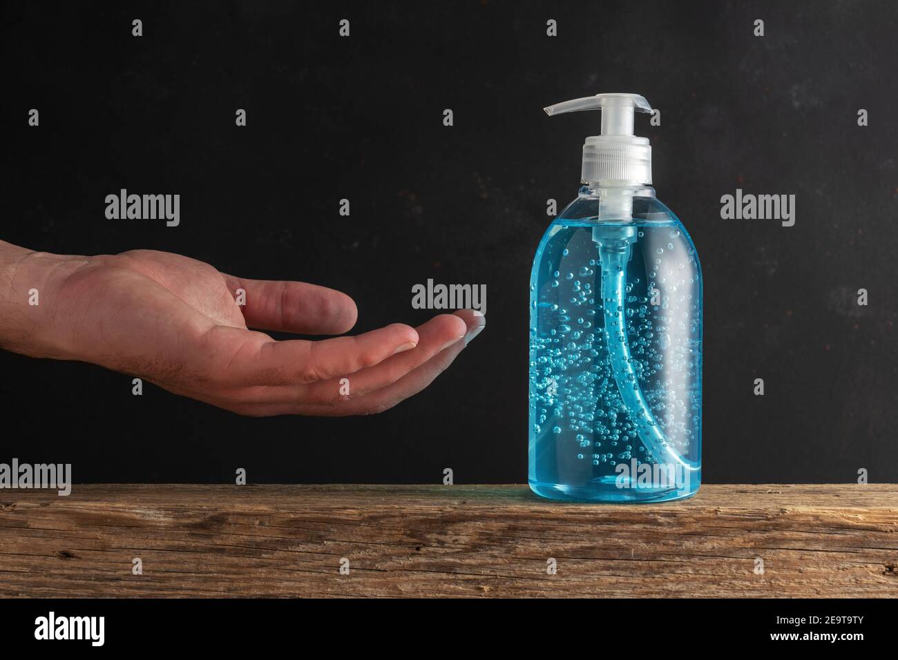 Man is using hand sanitizer alcohol gel to wash hands. Coronavirus ...