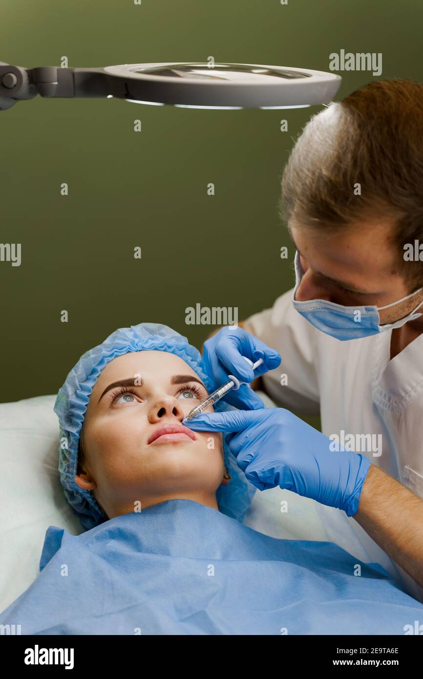 Lips augmentation injections for attractive girl on the green ...