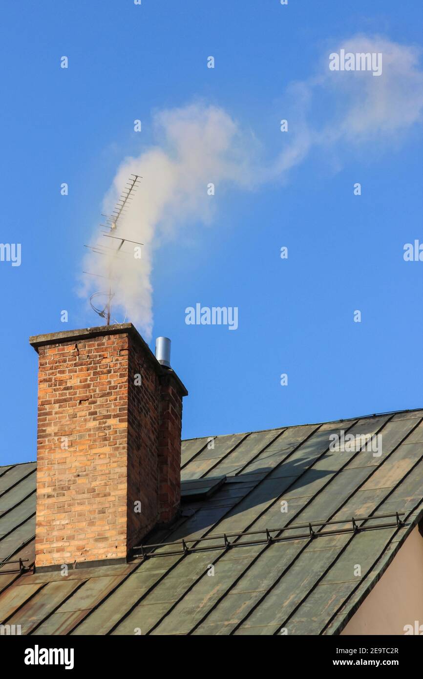 Smoke from a coal hearth coming out of a chimney. Air pollution Stock ...