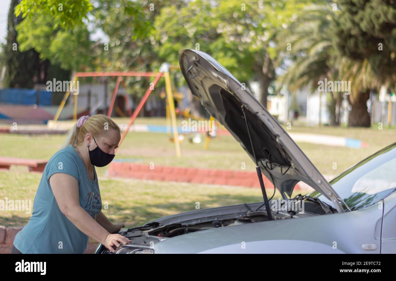 Woman with face mask with troubles in the car Stock Photo - Alamy