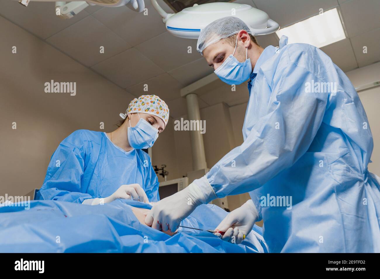 Liposuction for lipofilling surgery operation. 2 surgeon do plastic ...