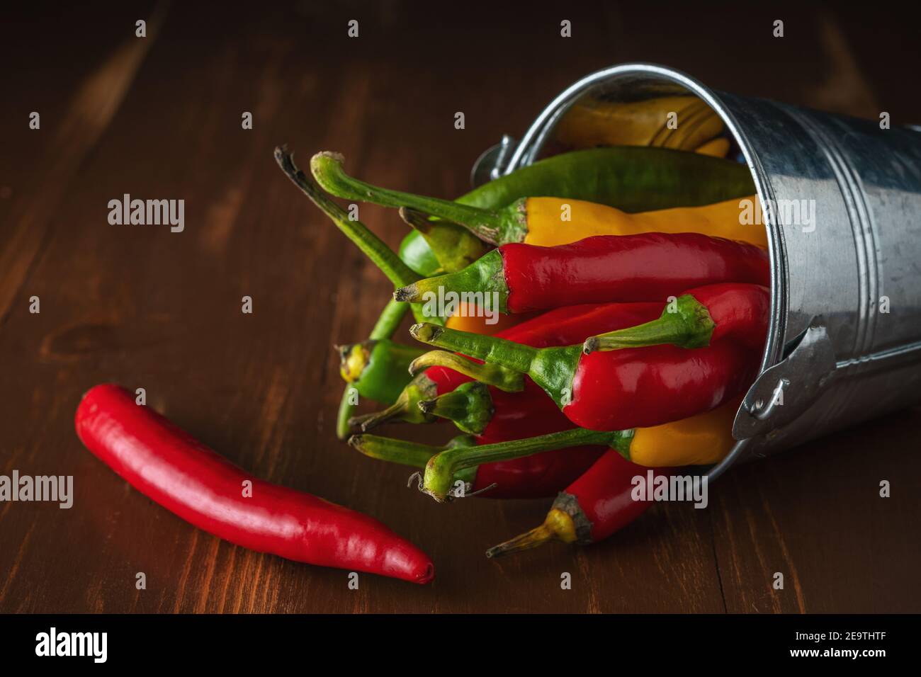 Red Chili Peppers in a bucket on old wooden background. Food background ...
