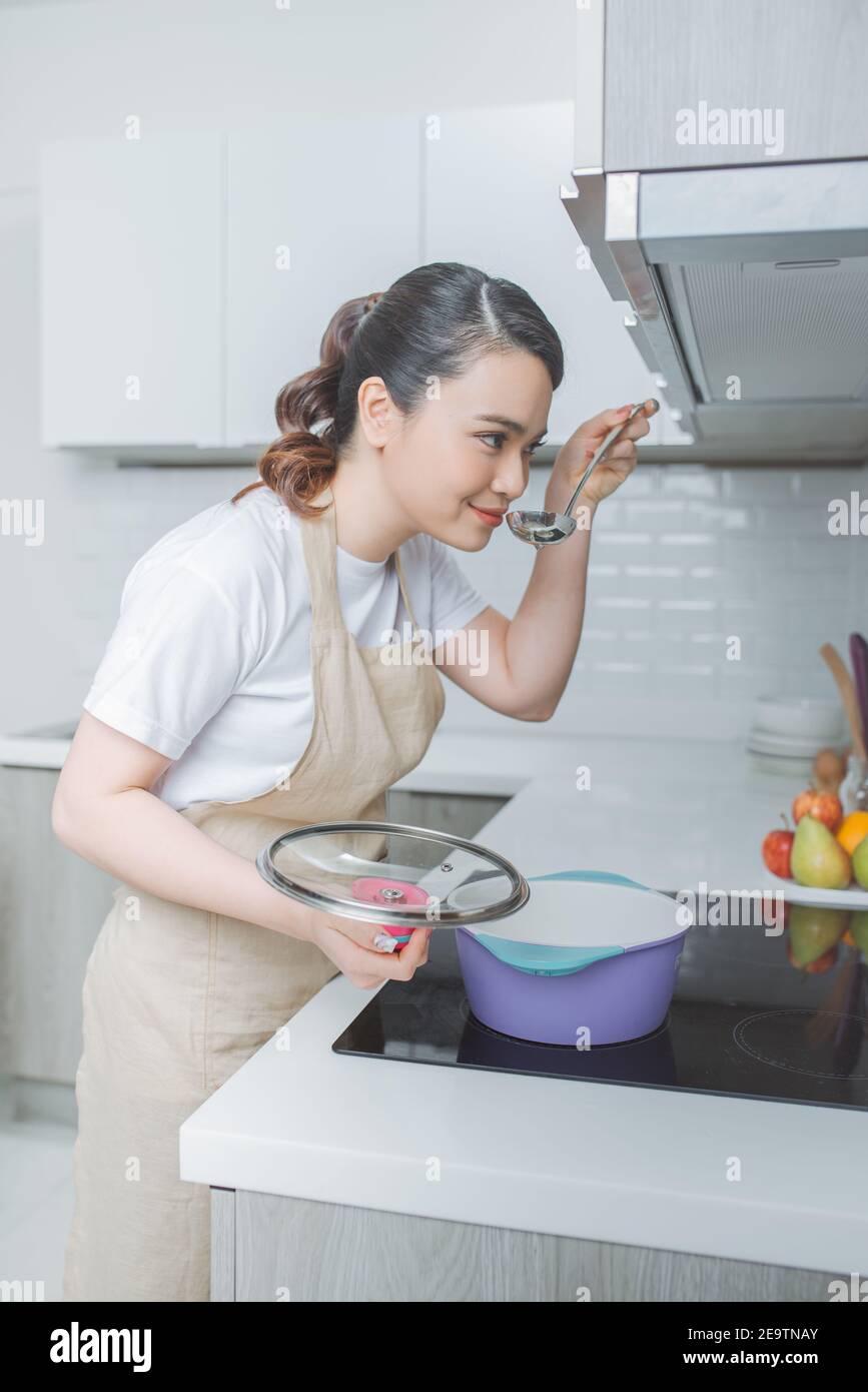 Woman tasting food hi-res stock photography and images - Alamy