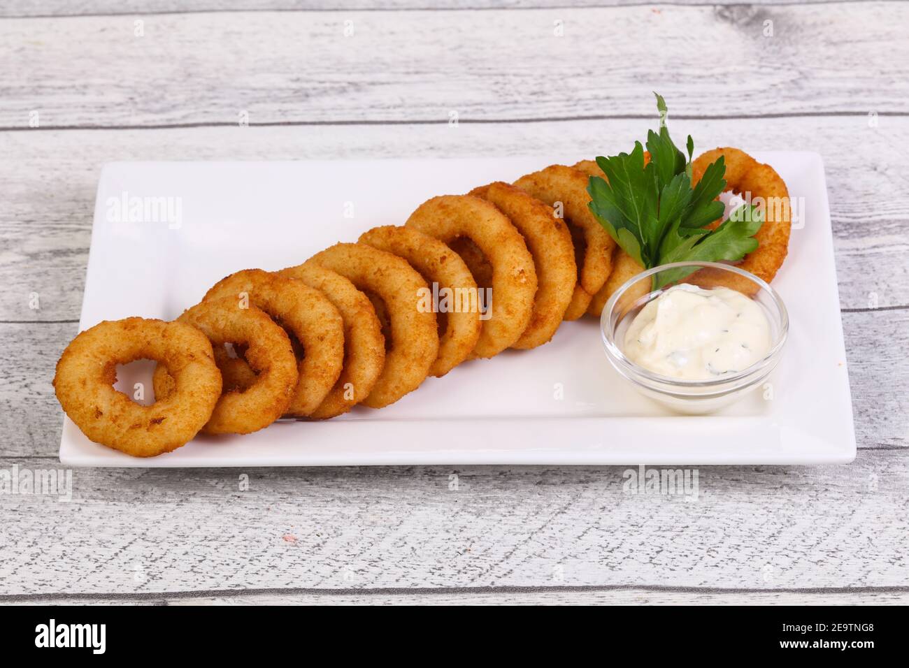 Squid rings snack with sauce served parsley Stock Photo - Alamy
