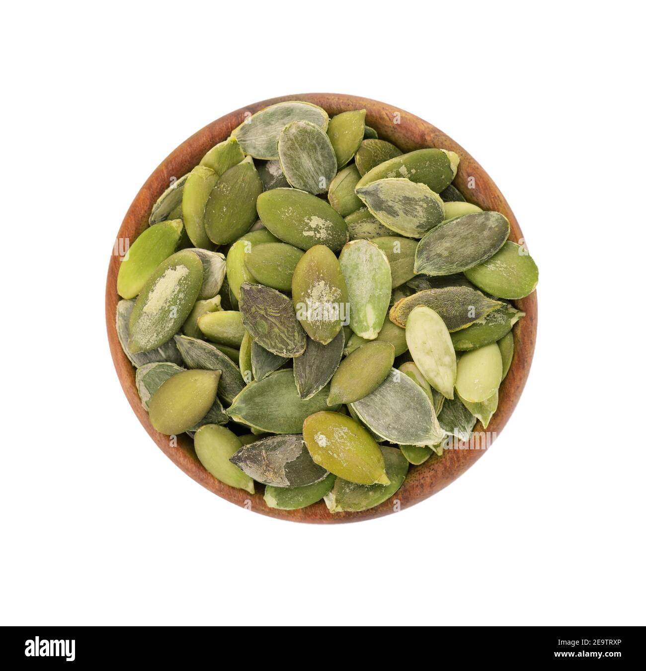 Pumpkin seeds in wooden bowl, isolated on white background. Green ...