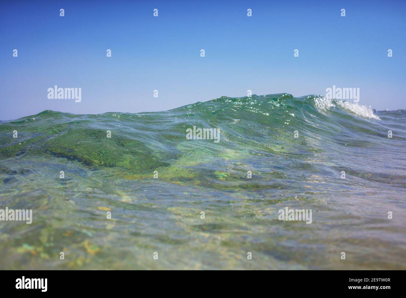 Blue wave on the beach. Blur background and sunlight spots. Dramatic ...