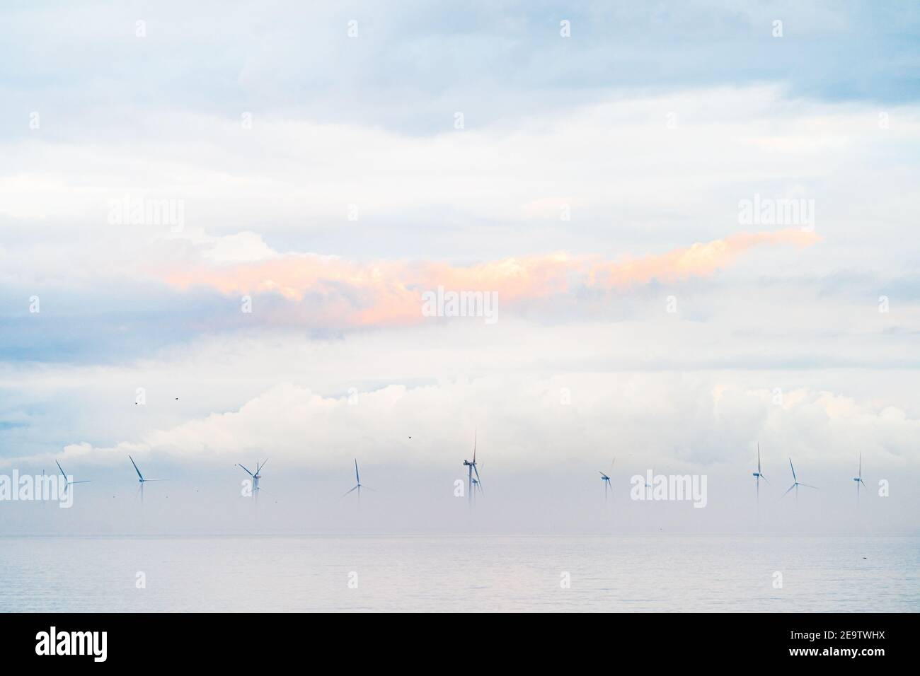 Wind turbines of the London Array offshore windfarm emerging from the ...