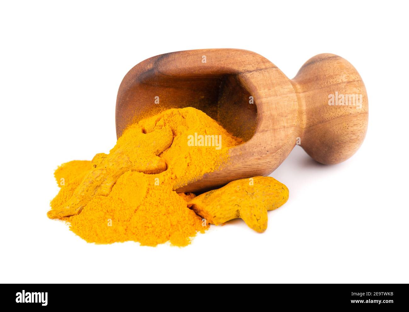 Dry turmeric powder in wooden scoop, isolated on white background ...