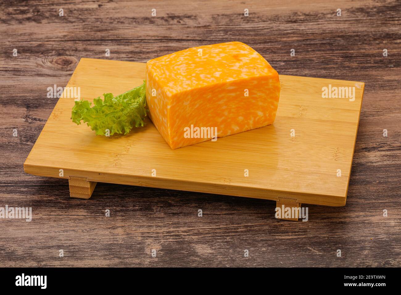 Dairy Marble cheese brick over board Stock Photo - Alamy