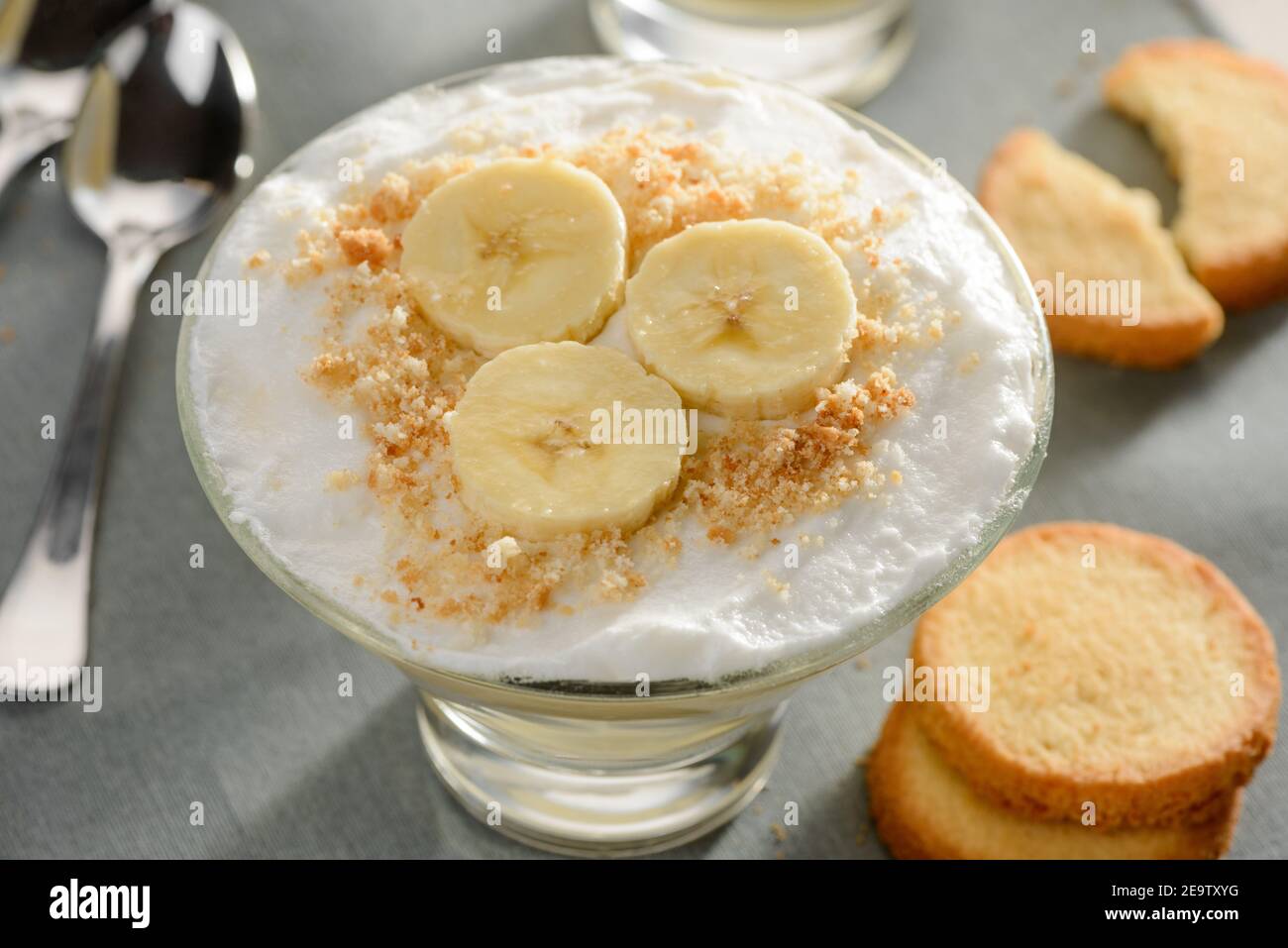 Beautiful dessert with heavy cream, banana slices and crumbed cookie ...