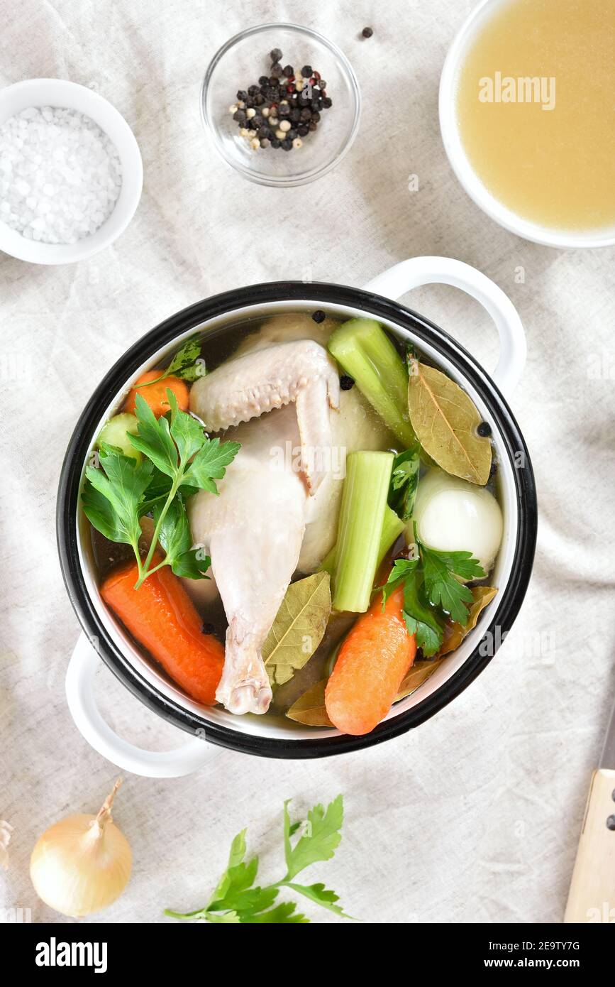 Chicken broth with vegetables and spices on light background. Healthy ...