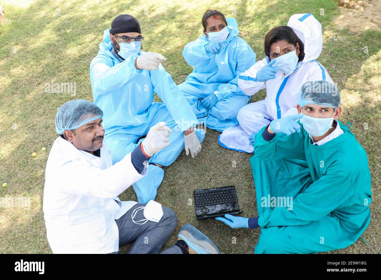 The Indian doctors pointing fingers while sitting on green grass Stock ...