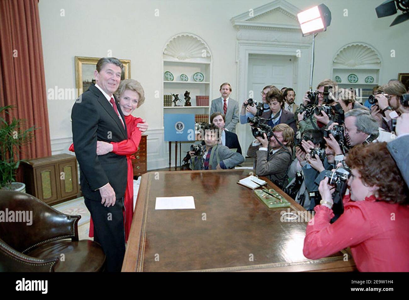 Nancy Reagan hugs President Reagan as he makes an address to the nation ...