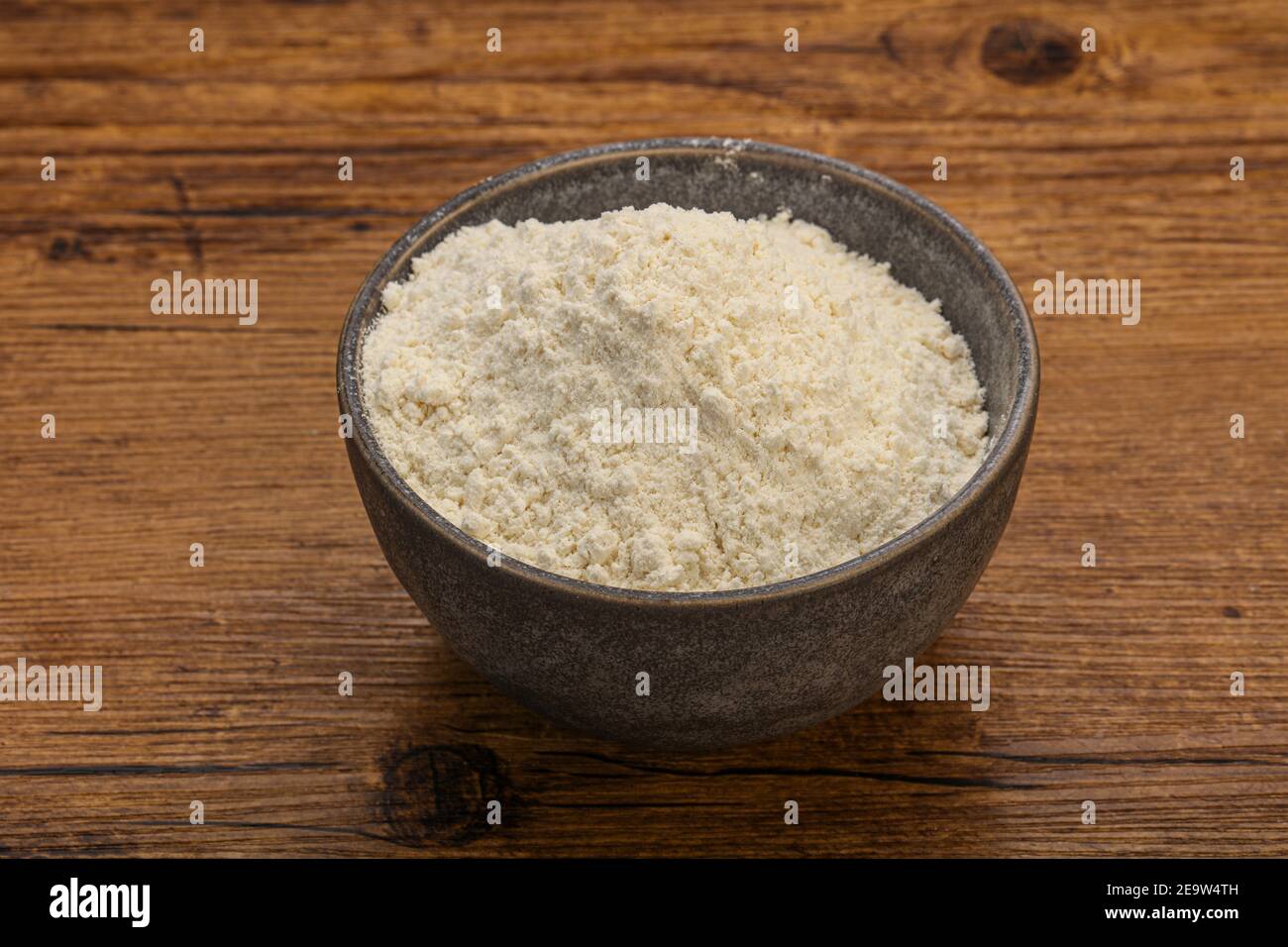 Wheat flour heap in the bowl for cooking Stock Photo - Alamy