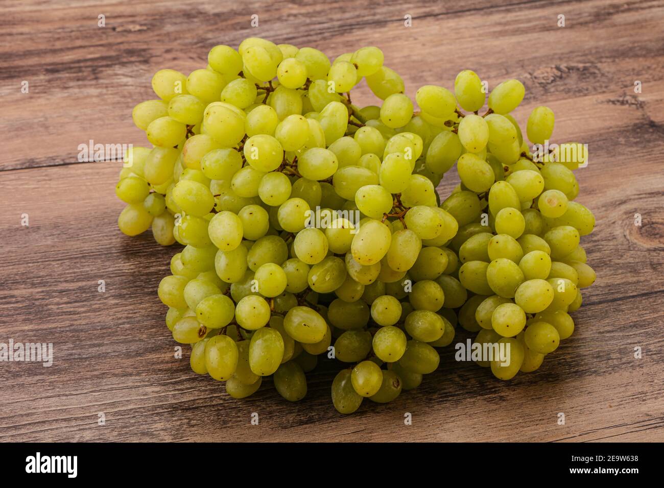 Sweet Green grape branch over background Stock Photo - Alamy