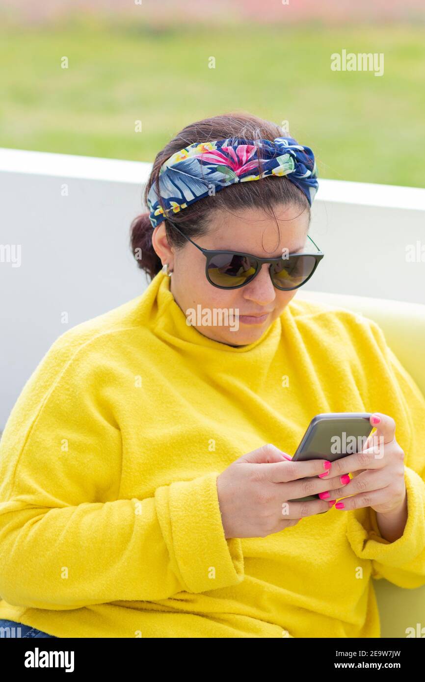 Adult woman checking smartphone hi-res stock photography and images - Alamy