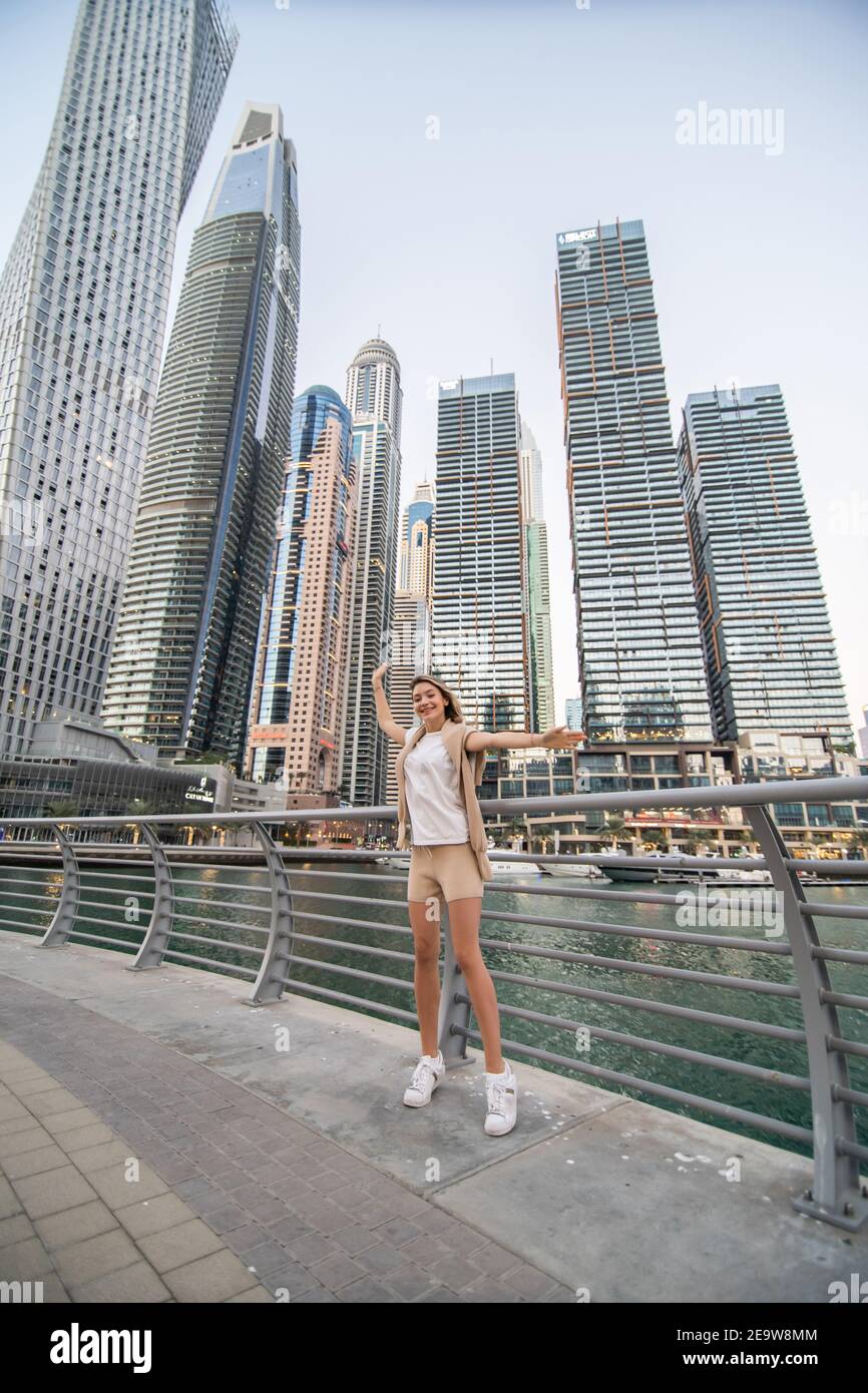 Low angle of woman in formal wear standing in megapolis on street near ...