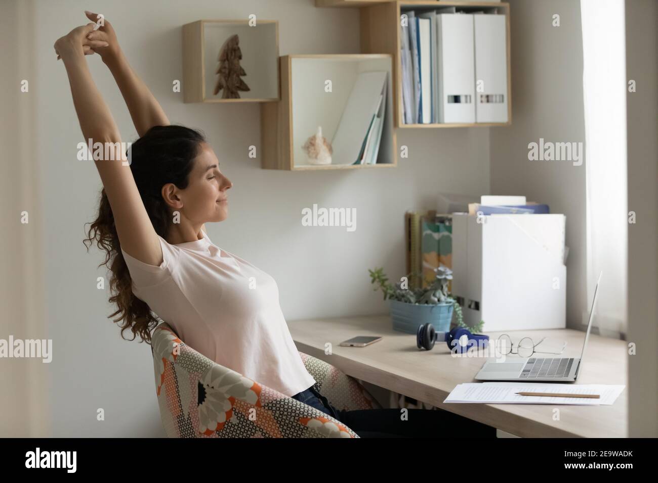 Happy young woman satisfied with finishing work relax stretch muscles ...