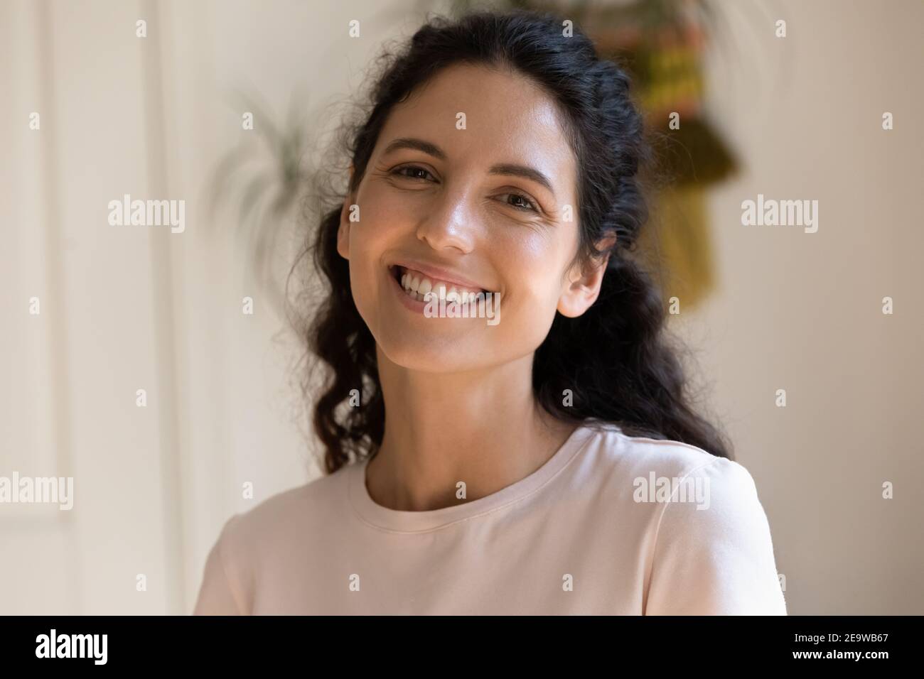 Adorable millennial female posing for headshot portrait looking at ...