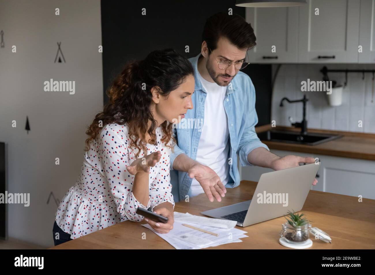 Family couple checking bank account confused with going over budget ...