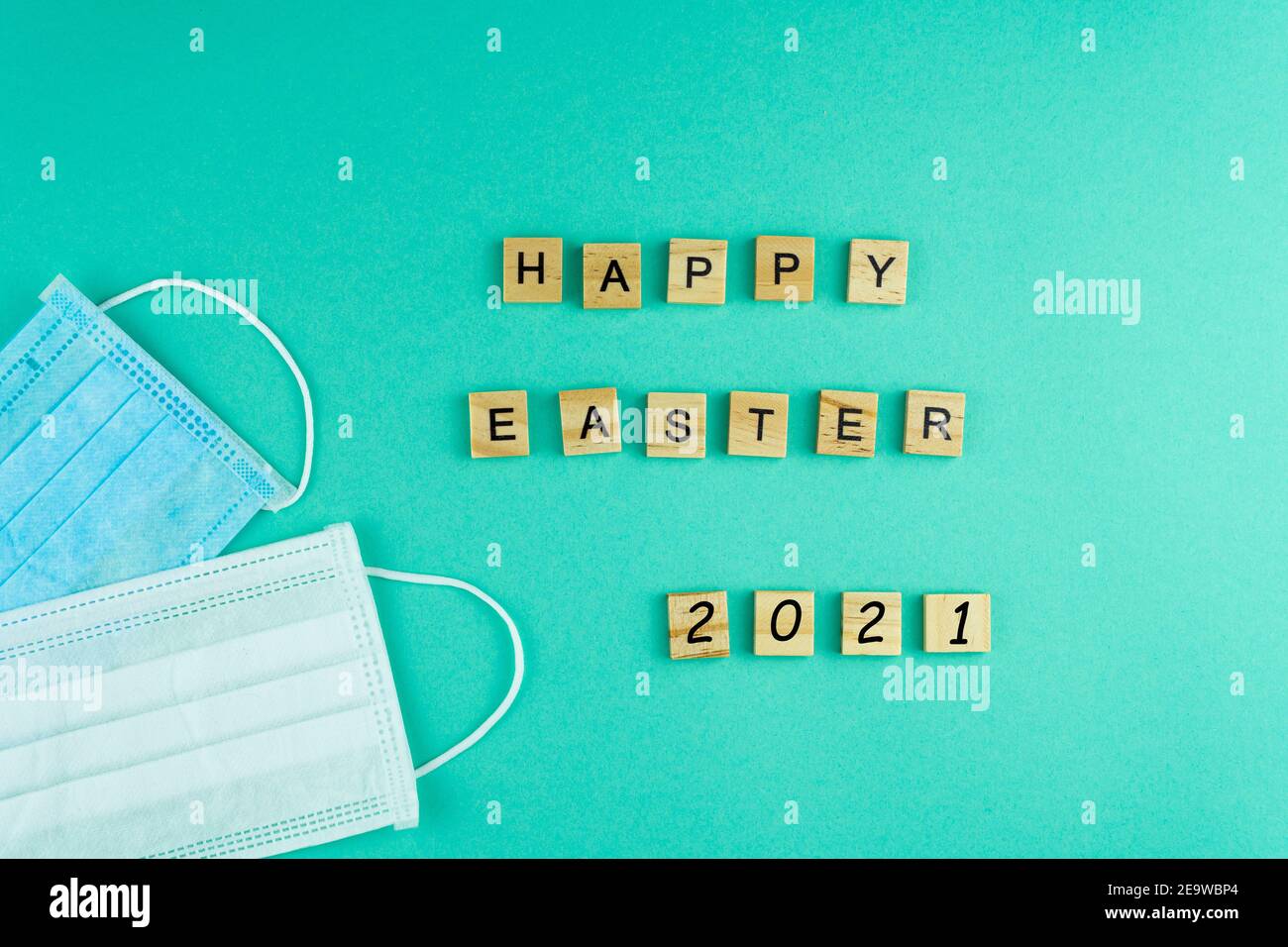 Happy Easter 2021 Medical masks. The phrase is laid out in wooden ...