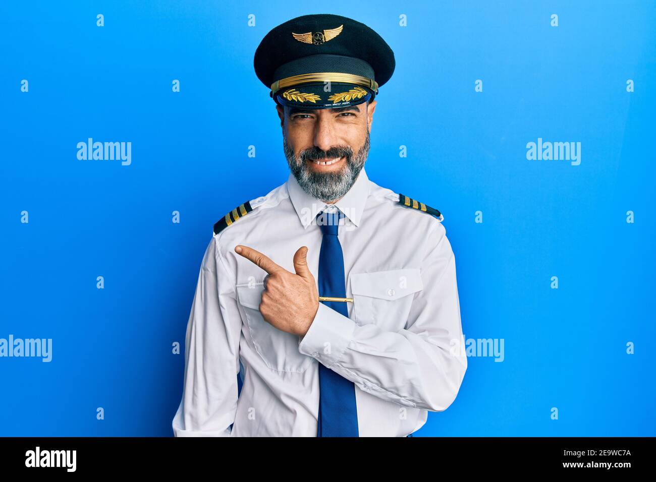 Middle age man with beard and grey hair wearing airplane pilot uniform ...