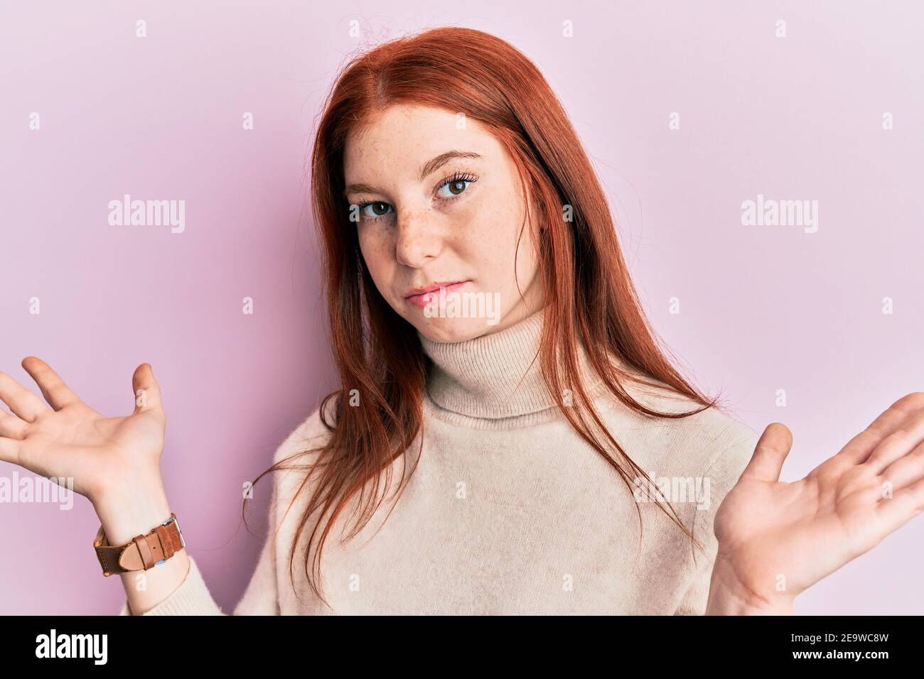 Young red head girl wearing turtleneck sweater clueless and confused ...