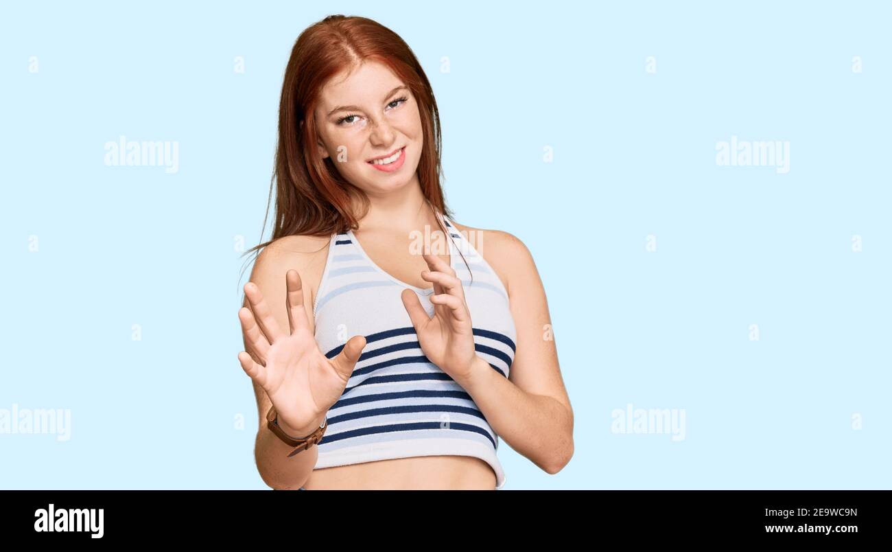 Young read head woman wearing casual clothes disgusted expression ...