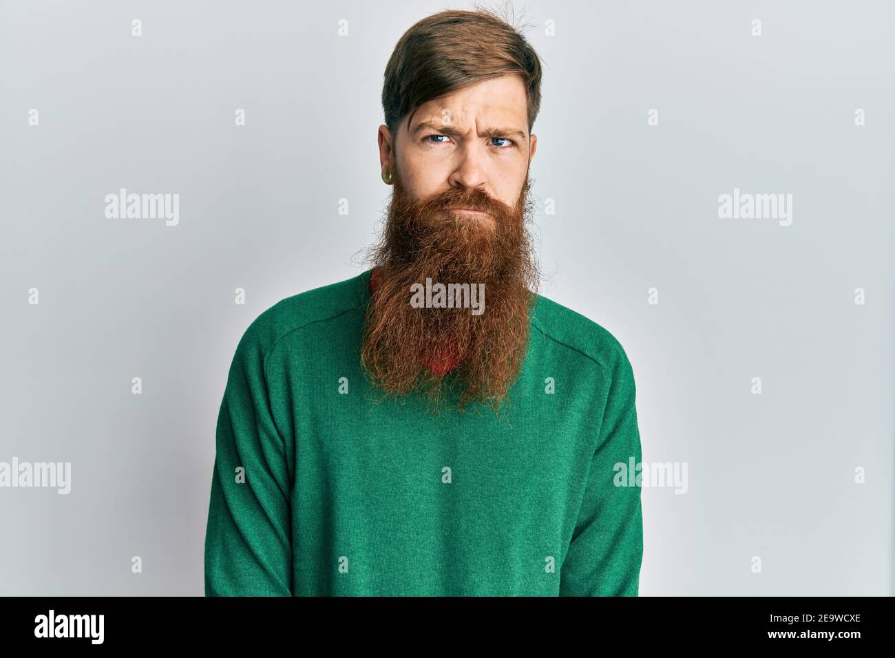 Redhead man with long beard wearing casual clothes depressed and worry ...