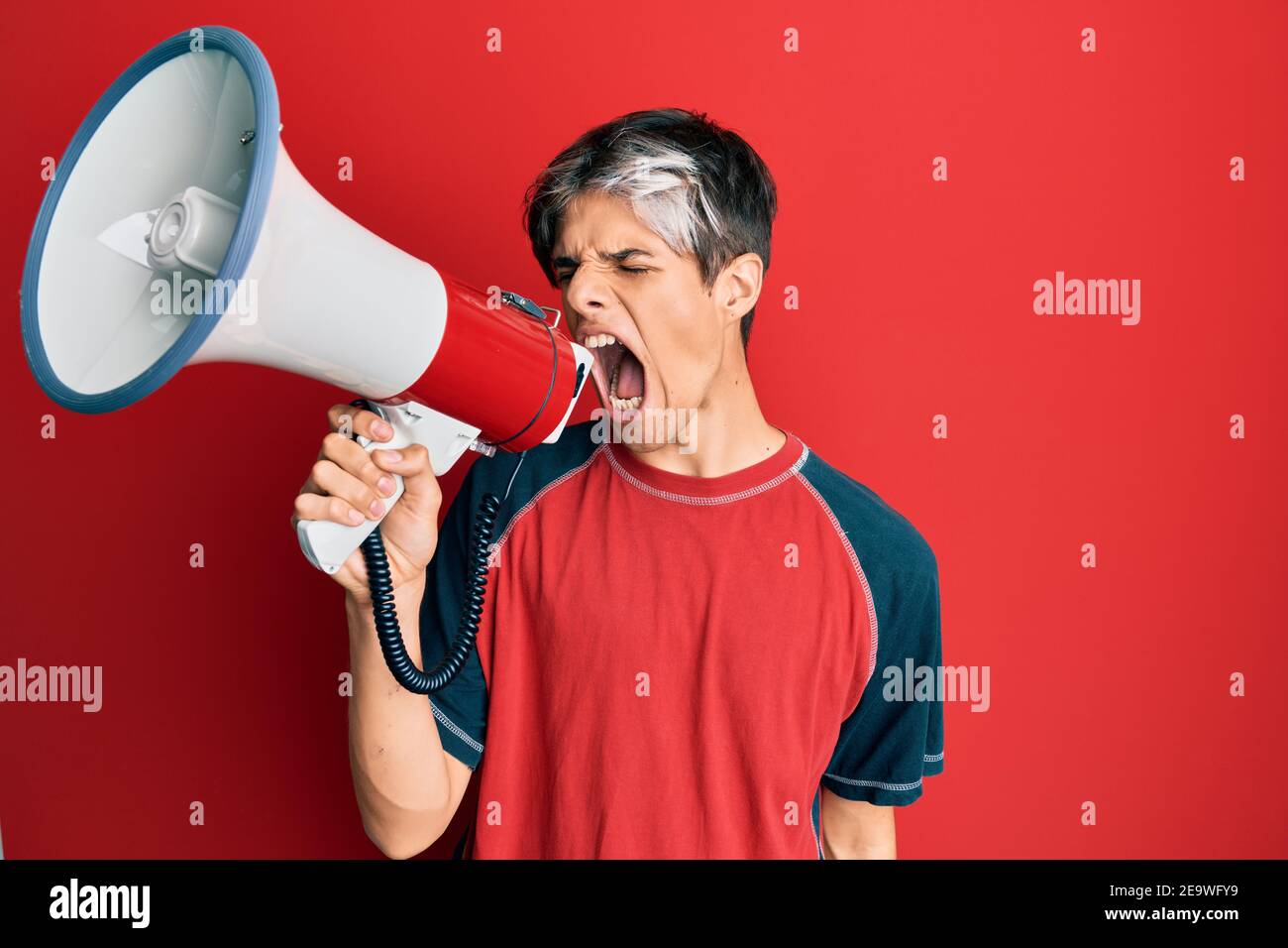 Young man shouting with anger and energy through megaphone Stock Photo ...