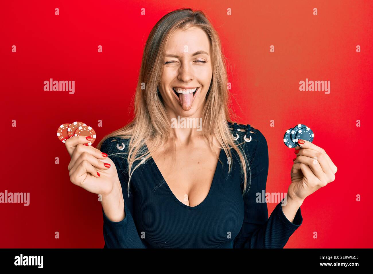 Beautiful caucasian woman playing poker holding casino chips sticking ...