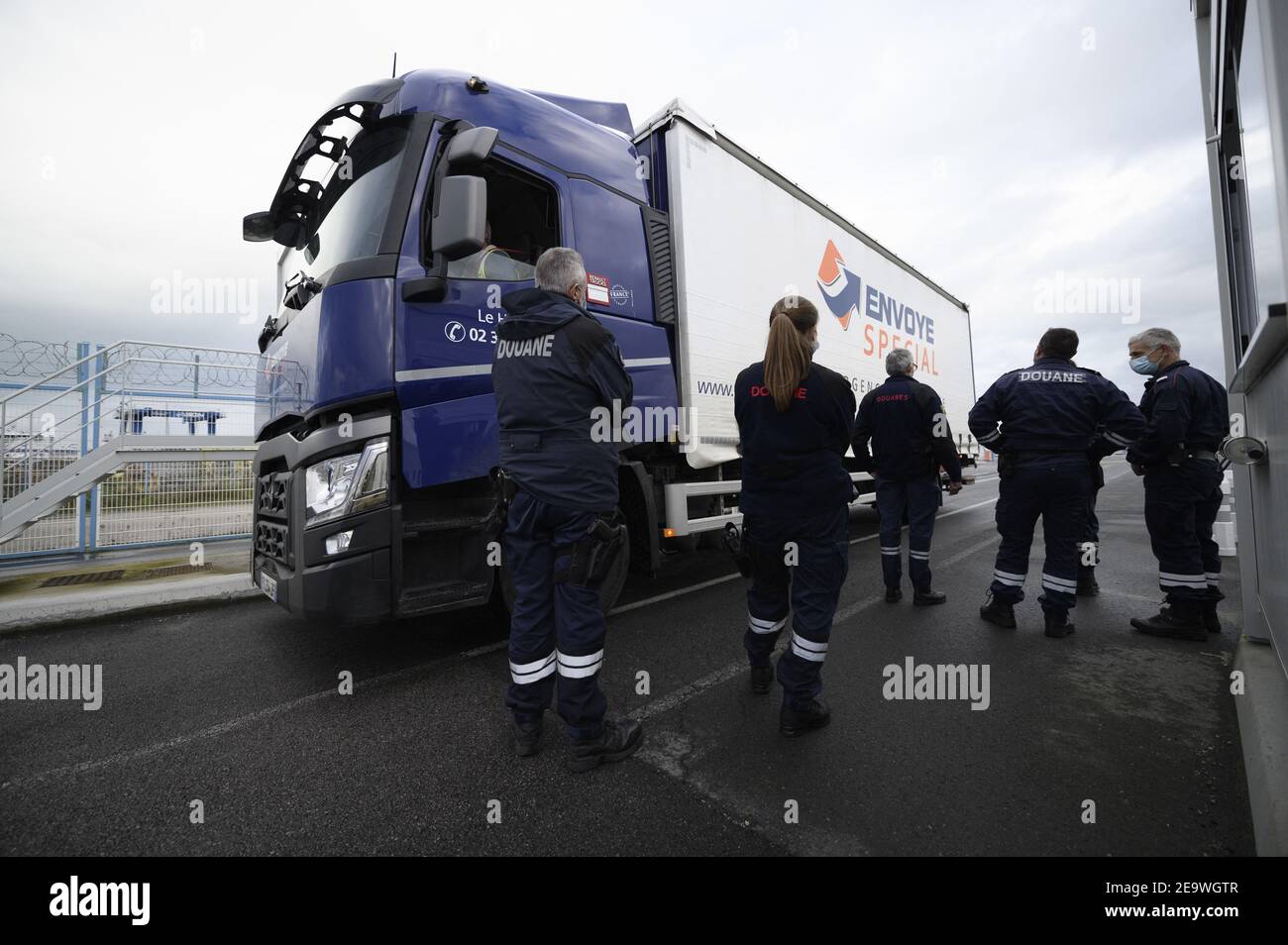 French Customs officers look on trucks arriving for embarkation at the ...