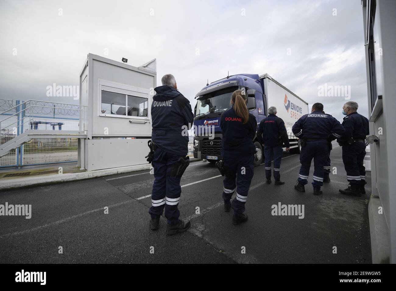French Customs officers look on trucks arriving for embarkation at the ...