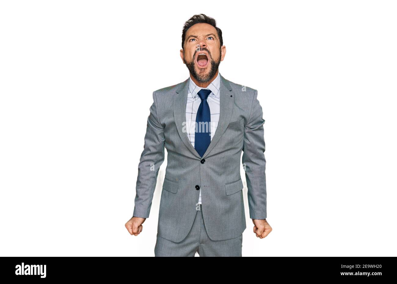 Middle age man wearing business clothes angry and mad screaming ...