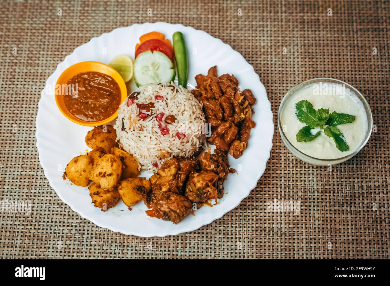 Varieties of Nepali food served together on the plate with sweet yogurt ...