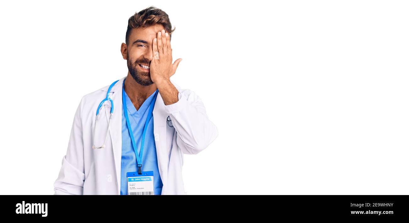 Young hispanic man wearing doctor uniform and stethoscope covering one ...