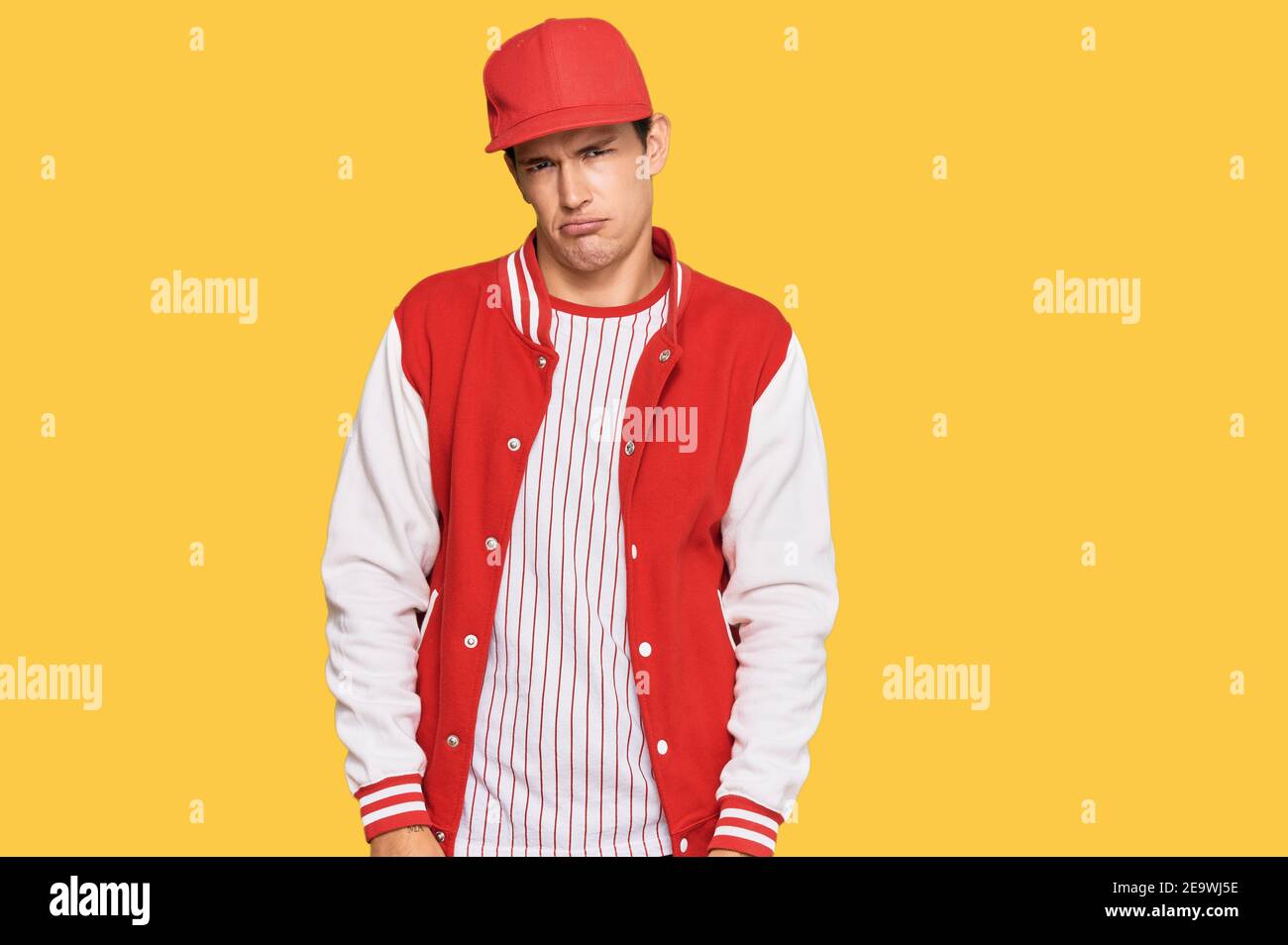 Handsome caucasian man wearing baseball uniform depressed and worry for ...