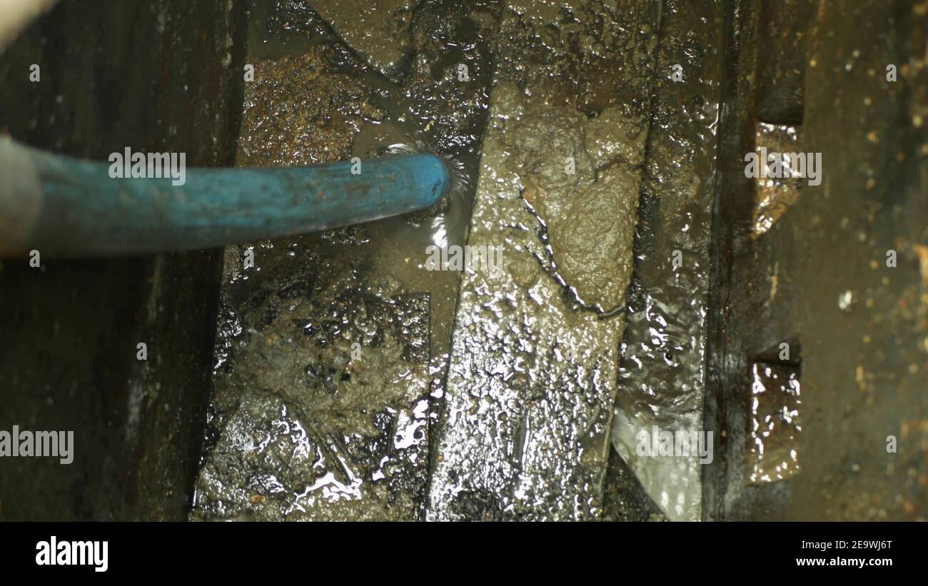 Septic cesspool pumping into tank by suction hose under high pressure ...