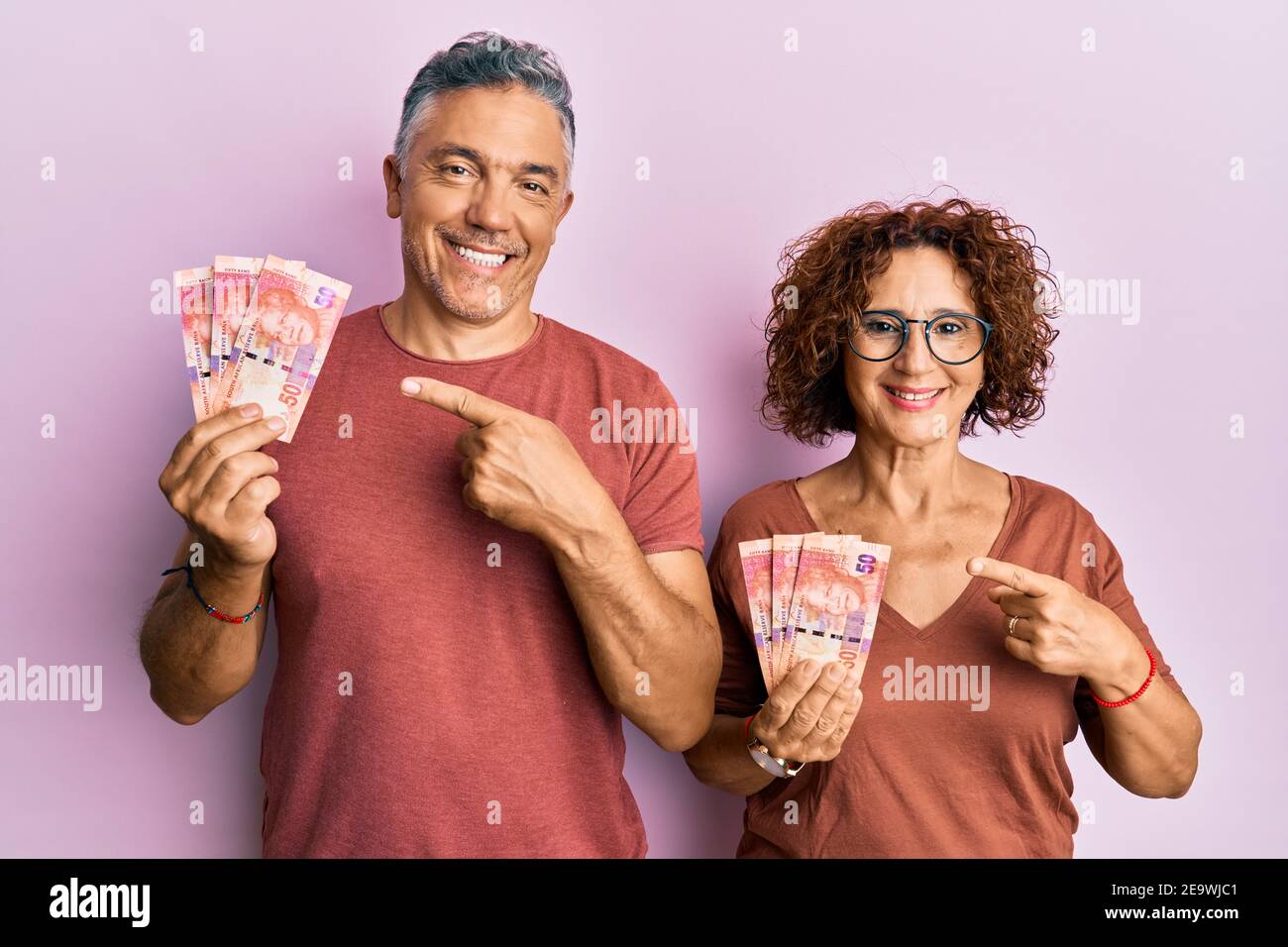 Beautiful middle age couple holding south african 50 rand banknotes ...