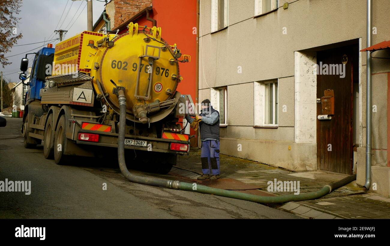 Septic cesspool pumping into tank truck by suction hose under high ...