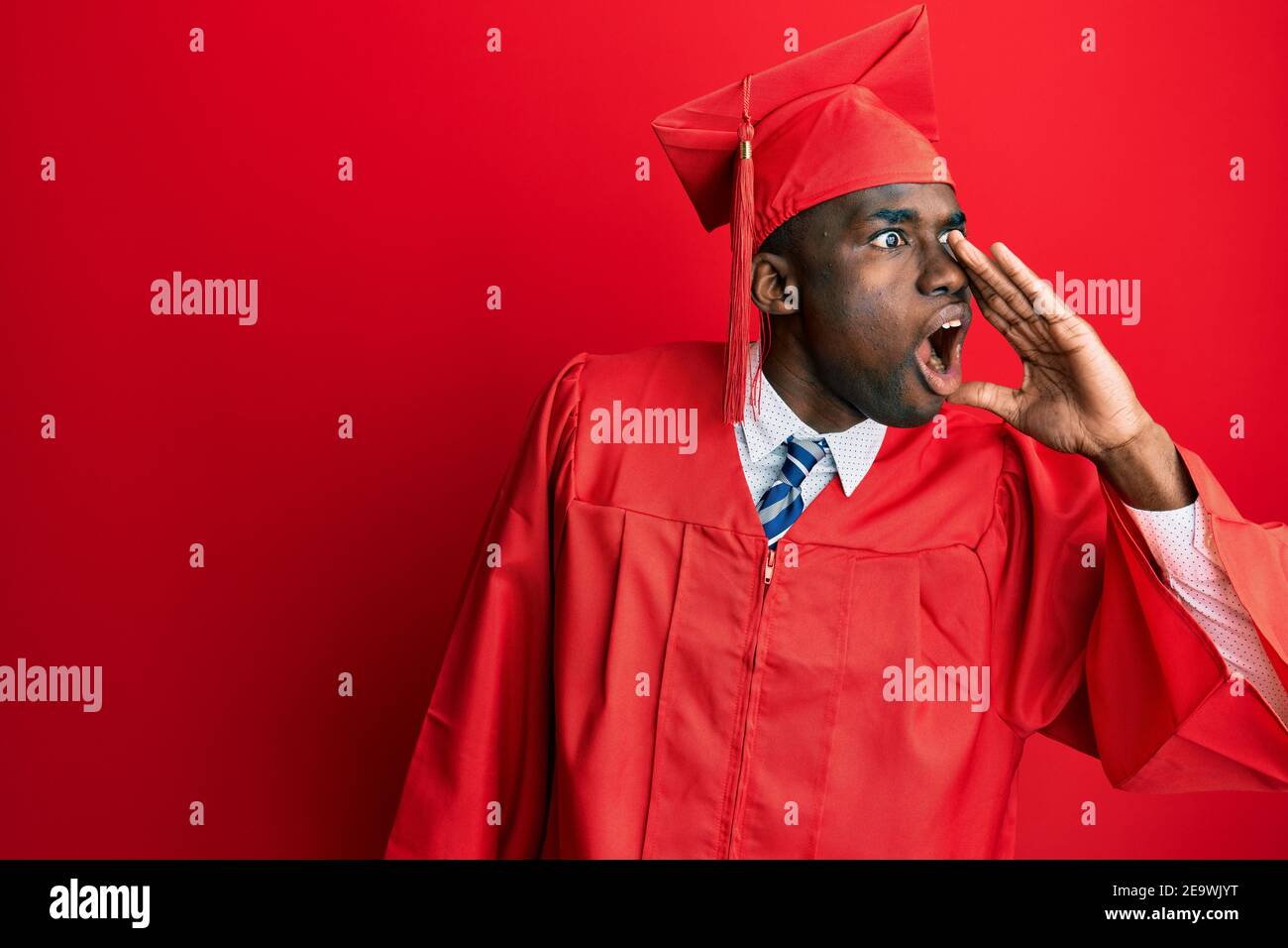 Young african american man wearing graduation cap and ceremony robe ...