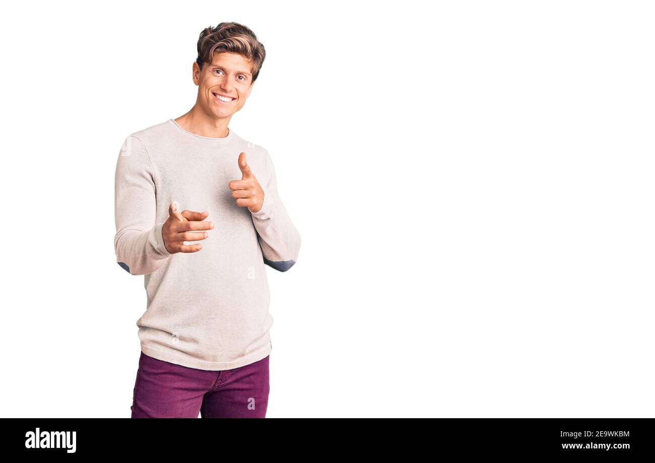 Young handsome man wearing casual clothes pointing fingers to camera ...