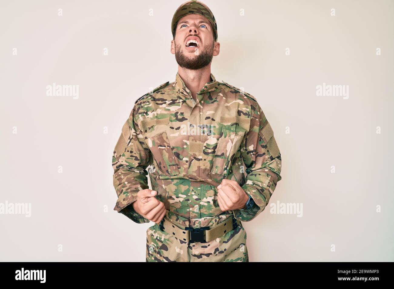 Young caucasian man wearing camouflage army uniform angry and mad ...